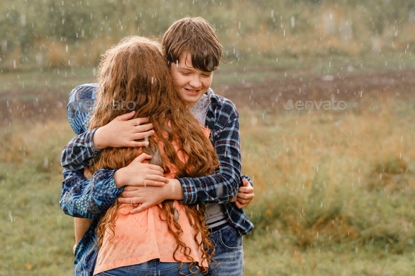 Children smile hugging outdoors. Friendship concept. Stock Photo by ...