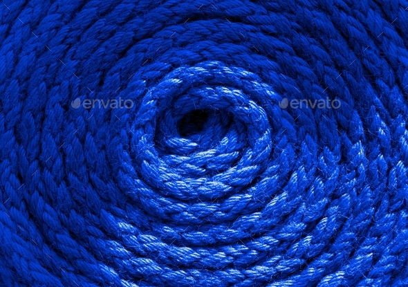 Heavy-duty bright blue coiled ships rope looking from above. Round ...