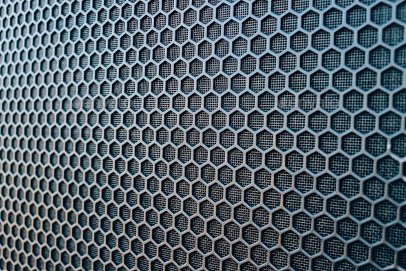 A speaker grill up close showing a repeating hexagonal pattern. Stock ...