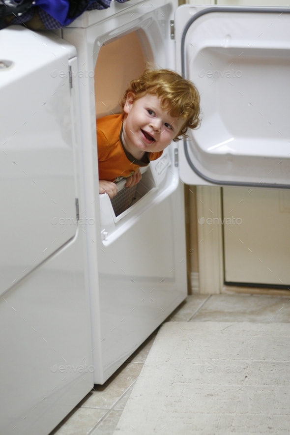 boy playing in the dryer. Stock Photo by starlingphotos | PhotoDune