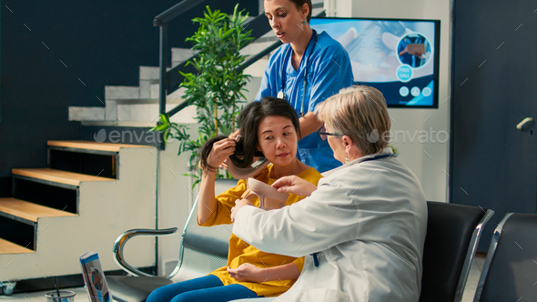 Medical staff helping asian patient to take off neck collar Stock Photo ...
