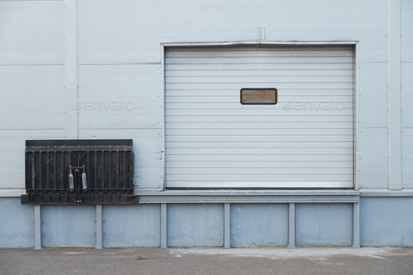 facade of a modern warehouse with roller shutters gate and lift Stock ...