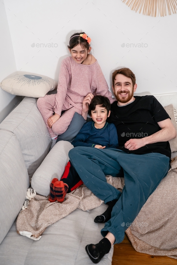 Multinational family with kids relaxing at home on sofa Stock Photo by ...