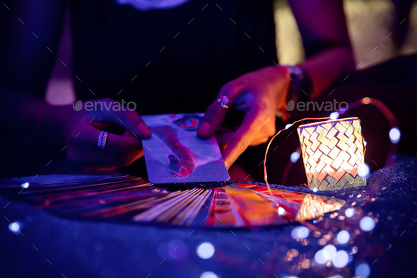 Woman’s hands holding a tarot card with fanned out cards Stock Photo by ...