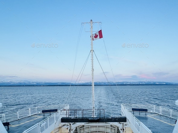 Sunrise on a ferry boat Canadian flag on mast symmetry Stock Photo by ...