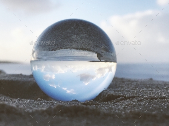 Glass ball at the beach with reflection Stock Photo by cobaltstock
