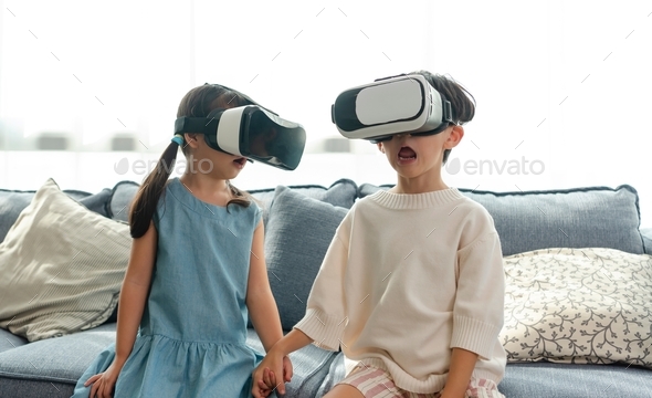 Asian child feeling excited while using 360 VR headset for virtual ...