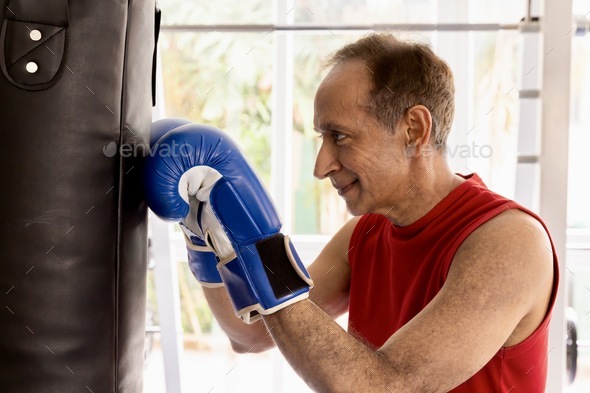 Active, happy senior boxing for a healthy lifestyle Stock Photo by lucky_ch