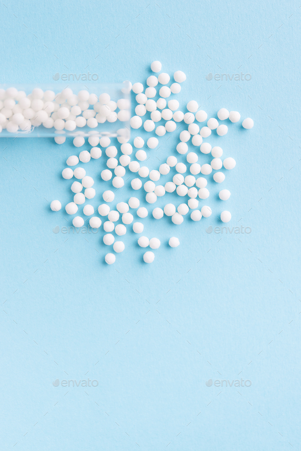Homeopathic pills on a blue background Stock Photo by olenasvechkova