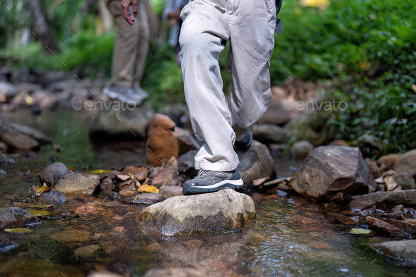 photo shot on backpack hiking traveler foot and leg walk step across on ...