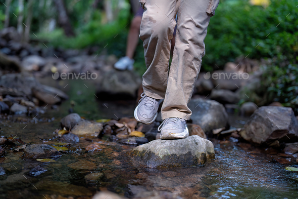 photo shot on backpack hiking traveler foot and leg walk step across on ...