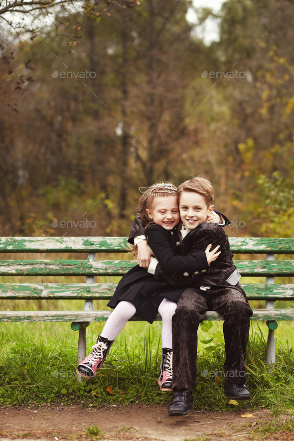 Brother and sister kids hugging on a bench Stock Photo by kegfire ...