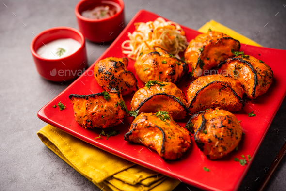 Tandoori momo, veg or non veg in red and cream sauce, served with sauce ...