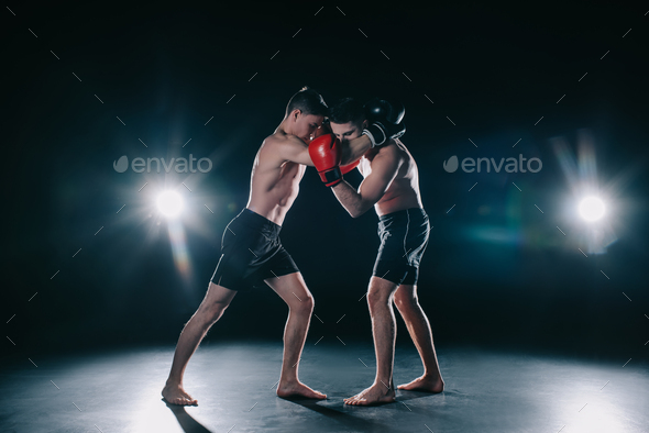 shirtless muscular boxers in boxing gloves standing in clinch Stock ...