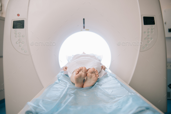 patient lying on computed tomography scanner bed during diagnostics ...