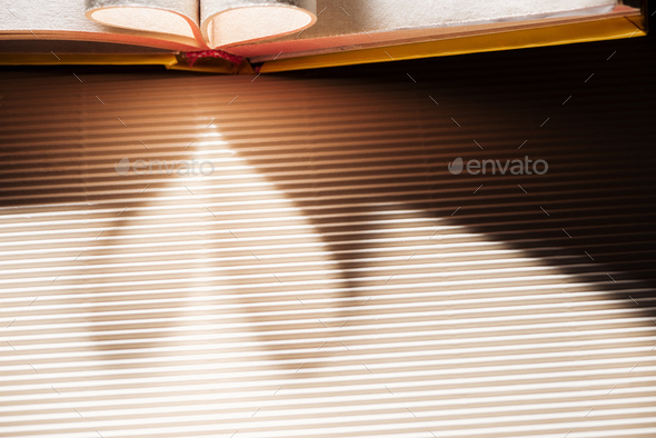 Open book with folded pages on textured surface with heart-shaped ...