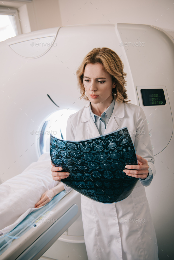 attentive radiologist examining tomography diagnosis during patients ...