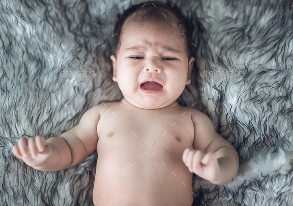 Baby girl crying in a wrap Stock Photo by FamilyStock | PhotoDune