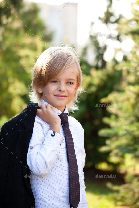 Outdoor portrait of Fashionable Schoolboy with school uniform, blonde ...