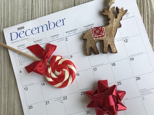 Looking down on a calendar turned to the month of December with various ...