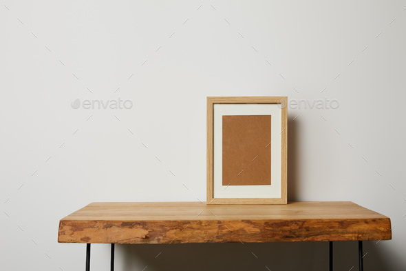 blank square frame on wooden textured table at home Stock Photo by ...