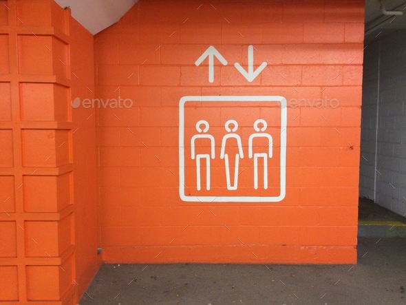 Orange sign showing elevator with people silhouettes Stock Photo by ...