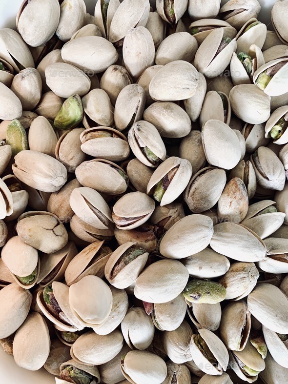 Pistachio nuts overhead close up natural light pastel earth colours ...