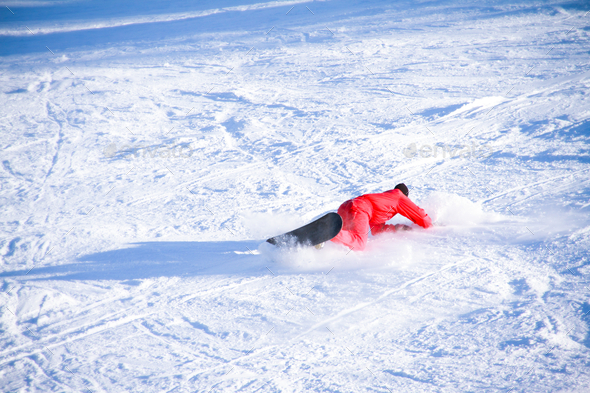 Man falling while snowboarding on a mountain Stock Photo by D_Yarko