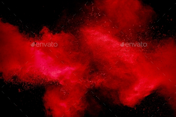 Red color powder explosion on black background.Freeze motion of red ...