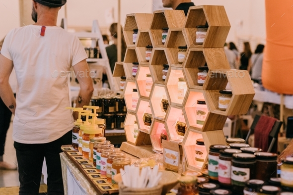 Selling locally produced honey, market stall, farm market. Bees ...
