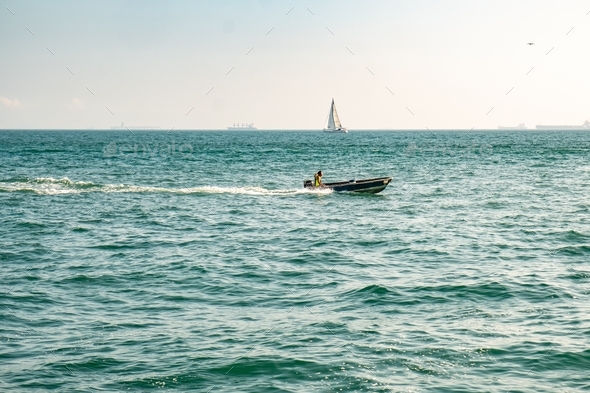 Motor boat moving fast in open sea with foam trace behind Stock Photo ...