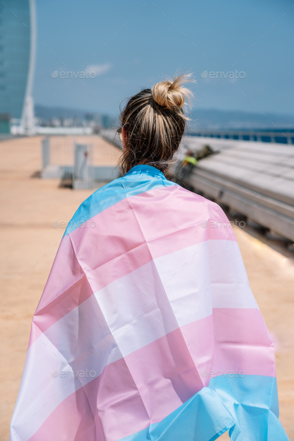 transsexual woman with trans flag, holding a transgender pride flag ...