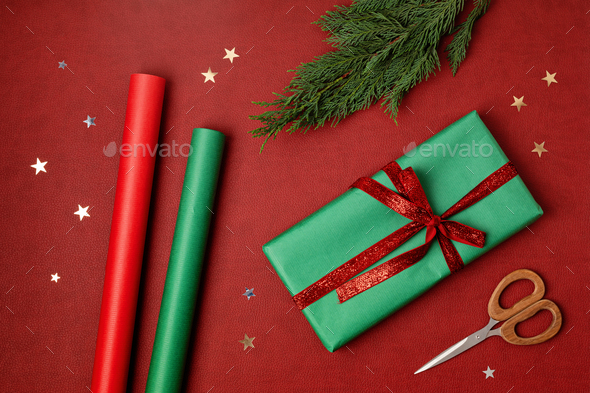 Christmas background with gift boxes and rolls of kraft wrapping paper ...