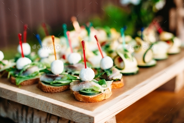 Delicious catering banquet buffet table. Different fish sandwiches with ...