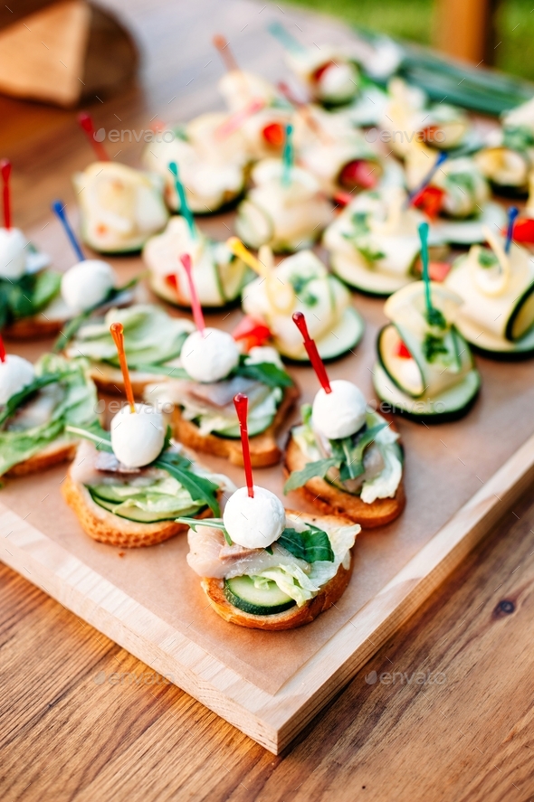 delicious catering finger food set with smoked fish and cheese ...