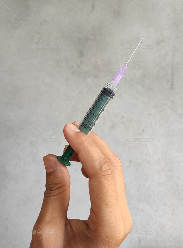 Injection syringe needle, hand holding disposal injection syringe with ...