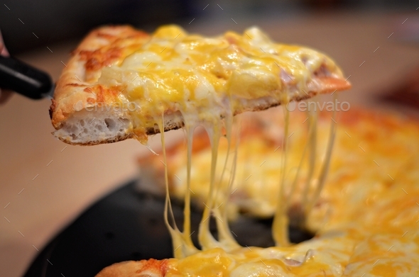 The cheese pull of a hot, gooey, cheesy slice of homemade pizza. Stock ...