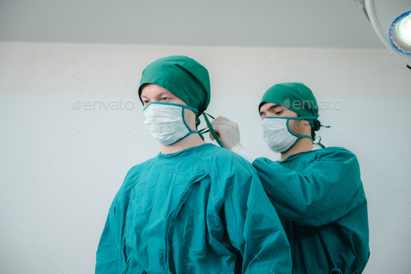 surgical doctor person are wearing protected suit medical operation ...