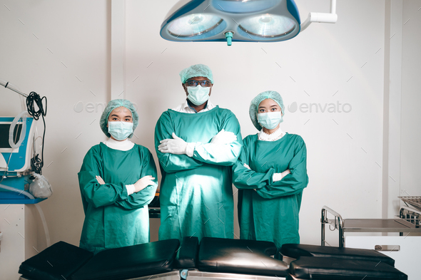 Group of concentrated surgeons team engaging in rescue of male patient ...