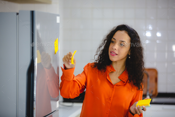 Young and organized female with curly hair in casual clothing making to ...