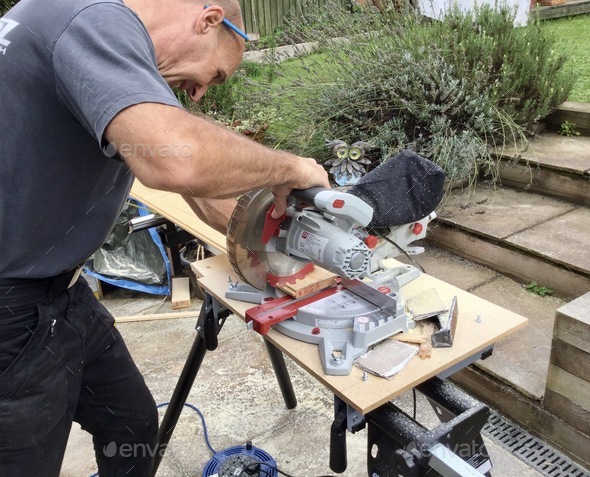 Man cutting wood with a circular saw in the garden for DIY Stock Photo ...