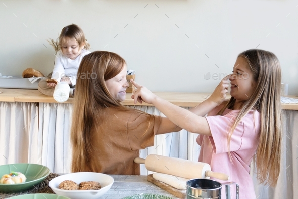 Children cheerfully cook and play in the kitchen. Stock Photo by ...