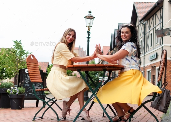 two friends at a table in a cafe in the French courtyard Stock Photo by ...