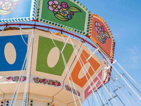 Bright and colorful carousel in the amusement park Stock Photo by VeraPolly