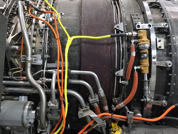 Jet engine closeup, metallic pipes, wires and mechanical systems ...