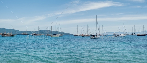 Panoramic distant view, yachts at anchor mooring in calm turquoise ...