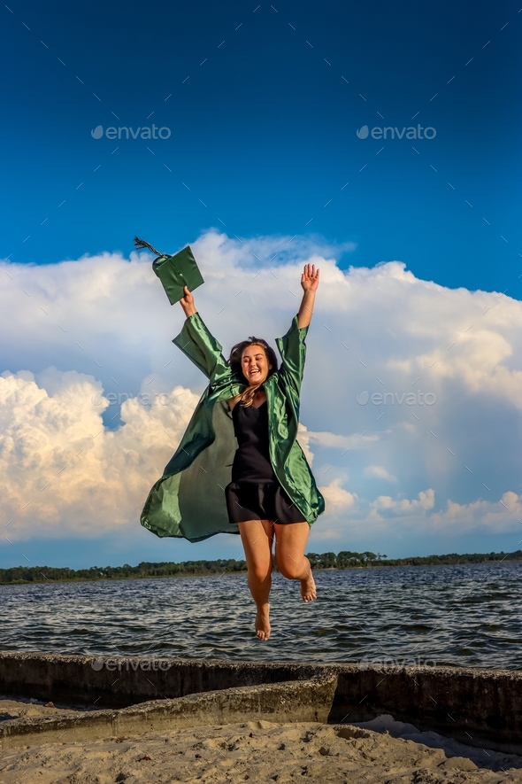 A young lady jumping for joy for graduation day. Congratulations Class ...