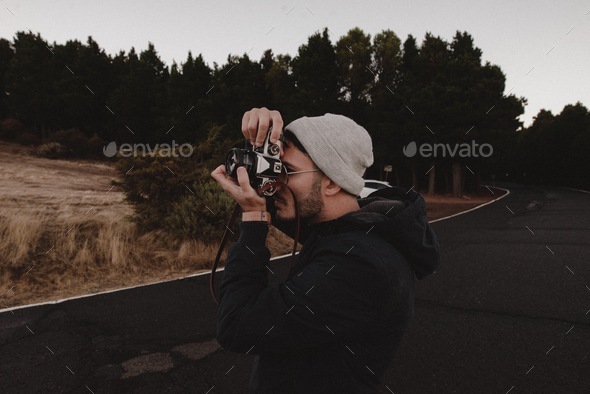 Man with a retro film camera snapping photos Stock Photo by isr4el