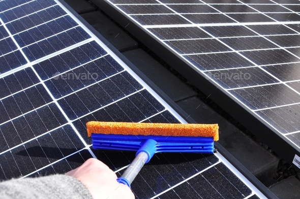 Cleaning solar panels with a wiper Stock Photo by fredlackner | PhotoDune