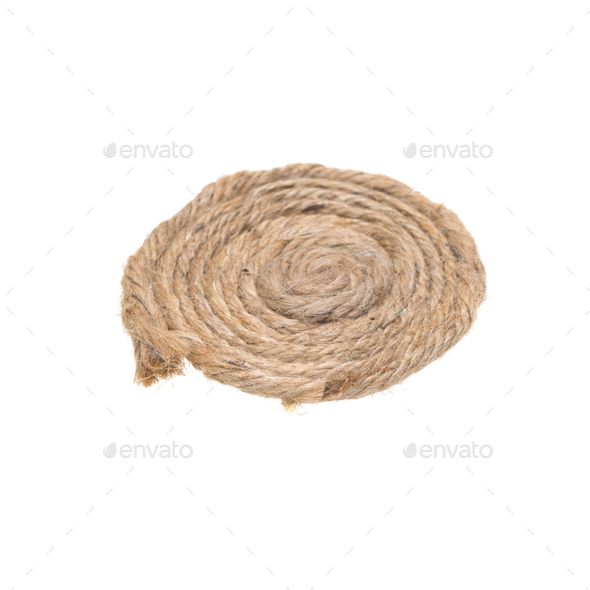 Hemp three strand rope coiled in a circluar pattern isolated against a ...